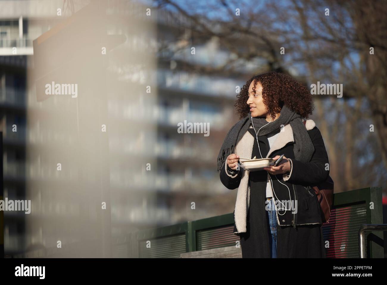 Lady at bus stop eating hi-res stock photography and images - Alamy