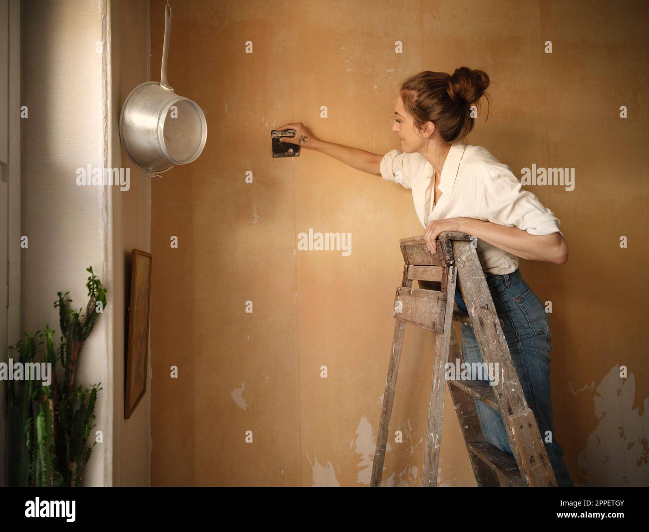 Woman on ladder hi-res stock photography and images - Alamy