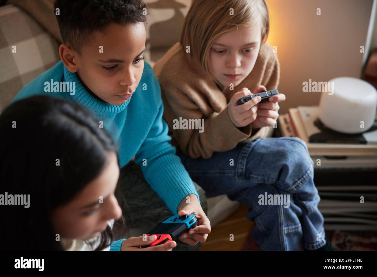 Children playing video games at home Stock Photo - Alamy