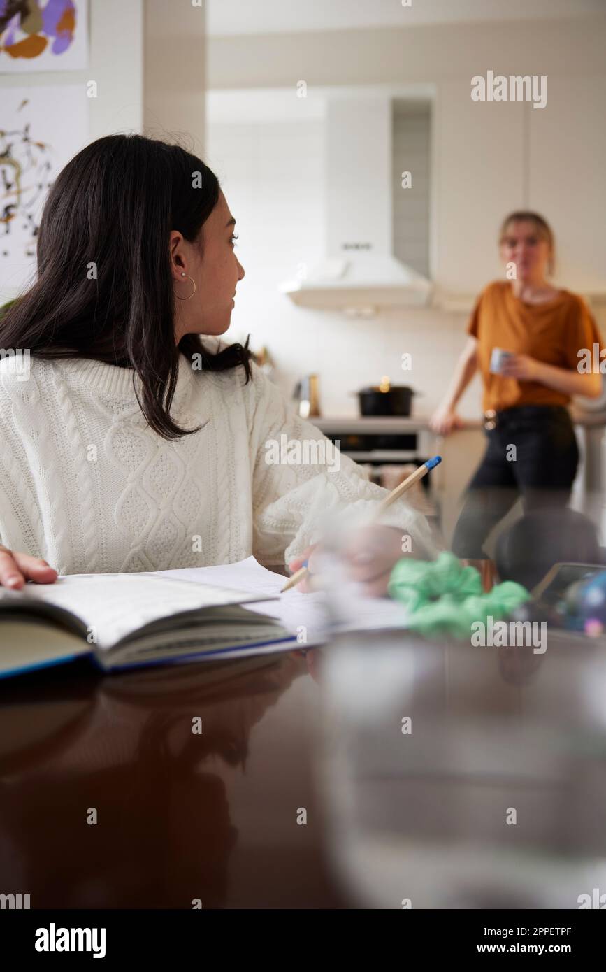 Girl doing homework at dining table Stock Photo - Alamy