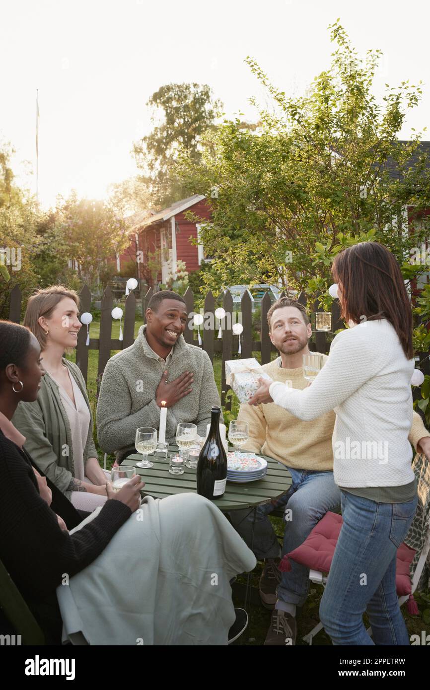 Happy friends having party in garden Stock Photo - Alamy