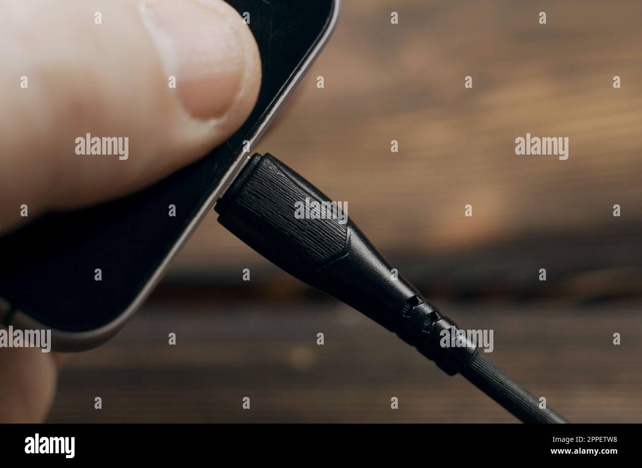 Close-up of connecting charging to the phone. Phone charging by wire ...