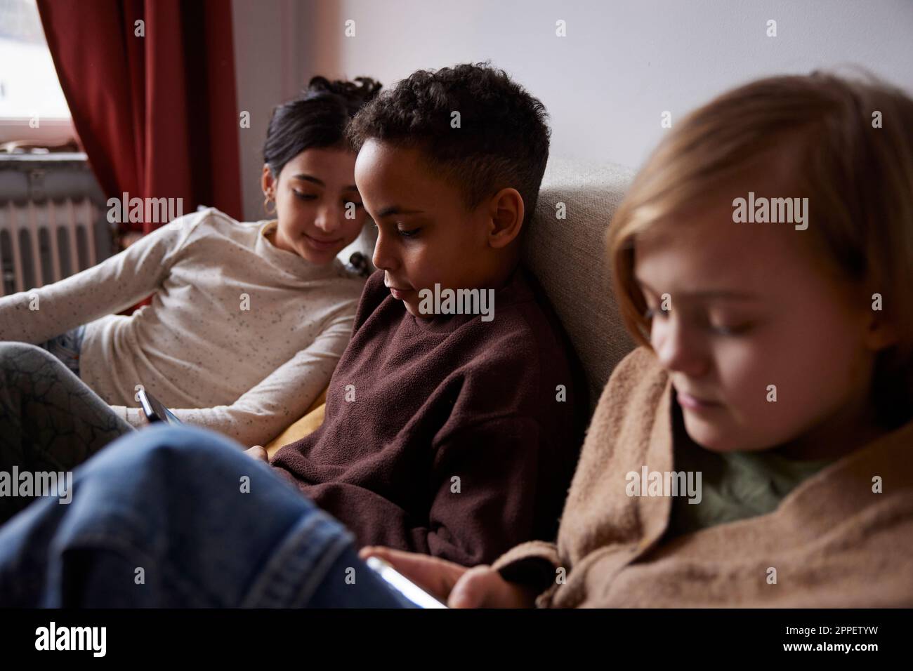 Children using phones at home Stock Photo - Alamy