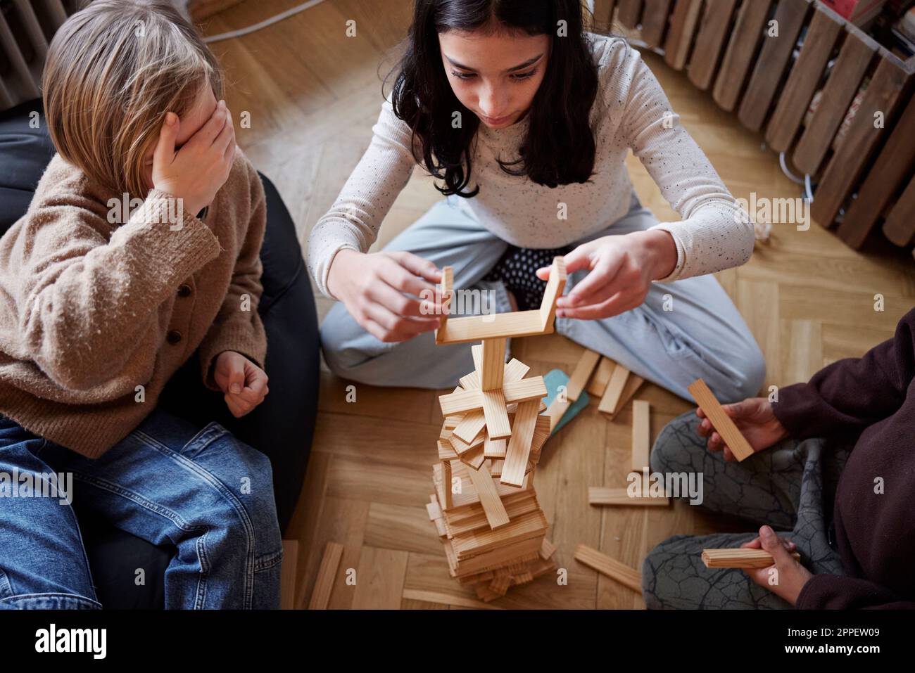 Children playing jenga at home Stock Photo - Alamy