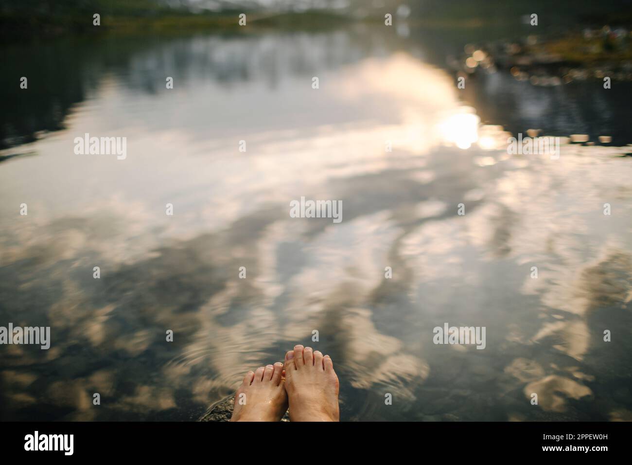 View of person's feet at water Stock Photo - Alamy