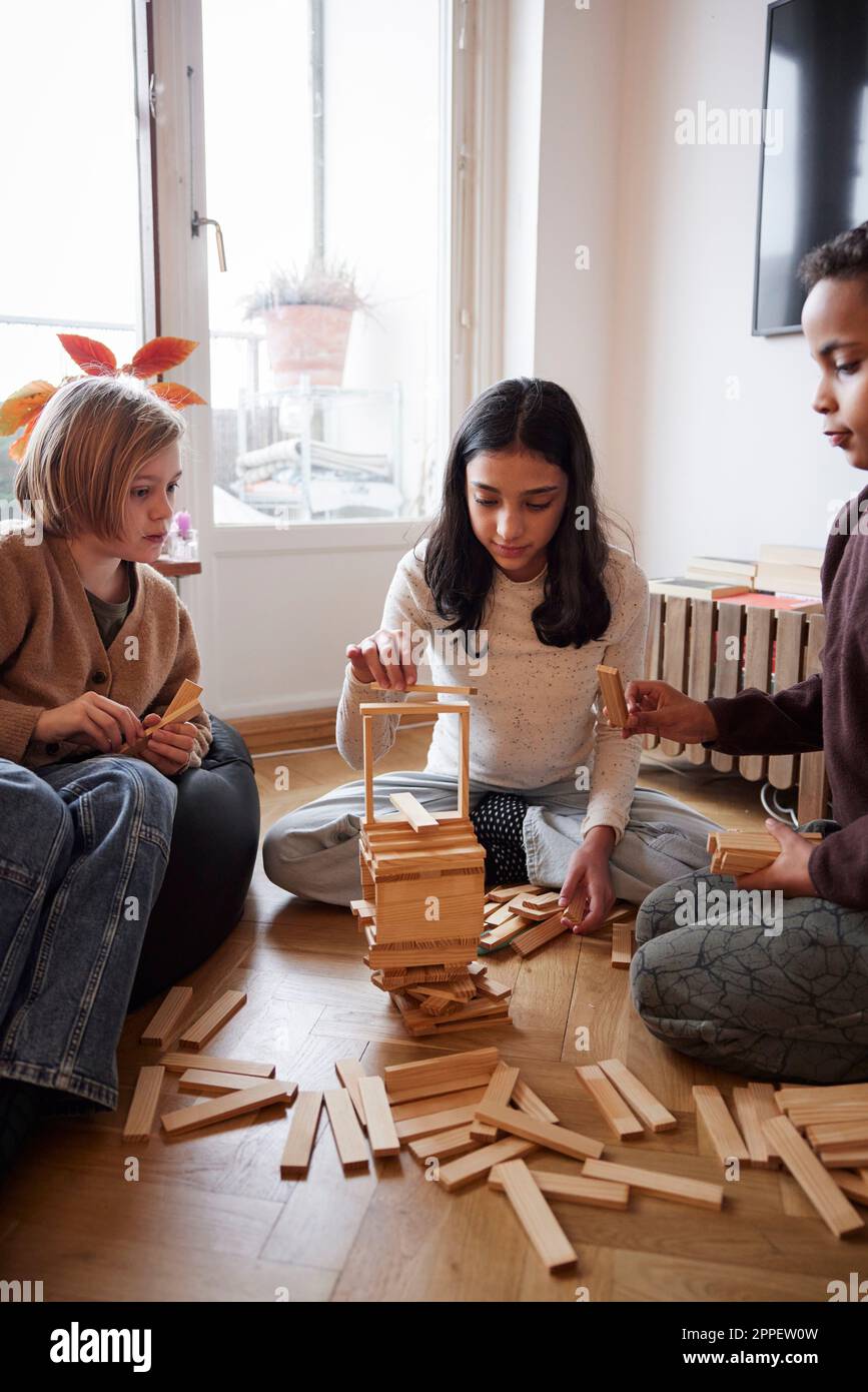 Children playing jenga at home Stock Photo - Alamy