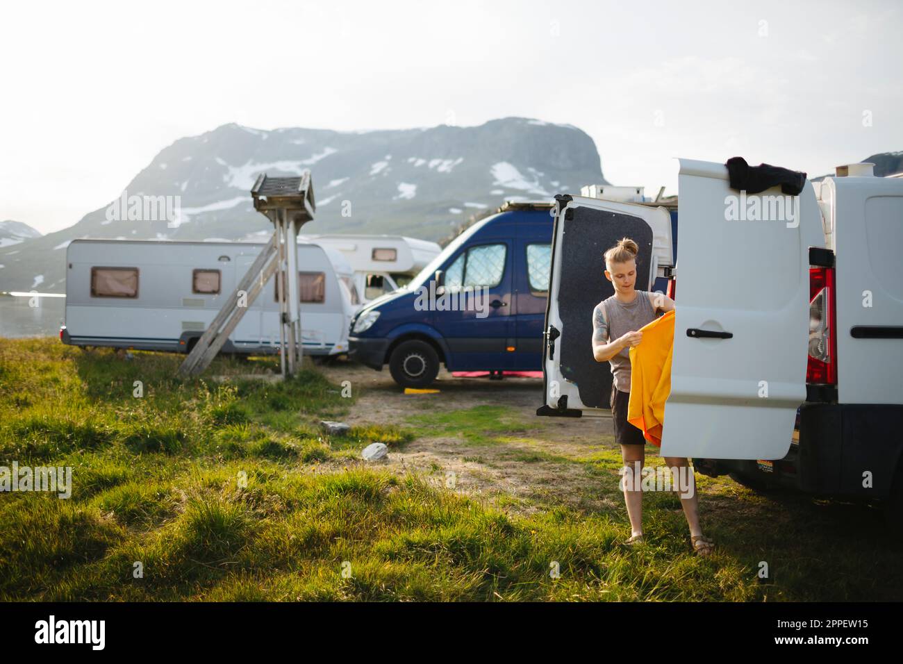 Woman standing in front of open van Stock Photo - Alamy