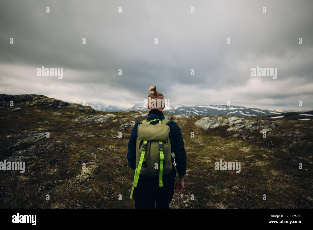 Rear view of hiker in mountains Stock Photo - Alamy