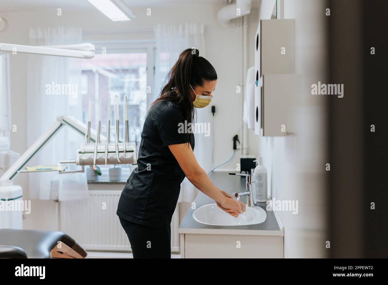 Female dentist washing hands hi-res stock photography and images - Alamy