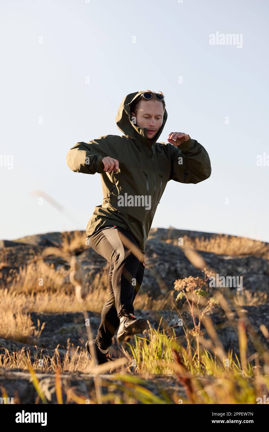 View of man running outdoors Stock Photo - Alamy