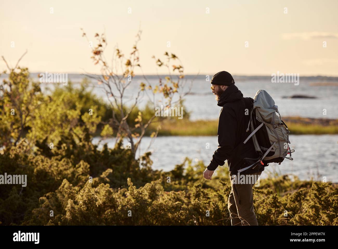 View of backpacker walking at sea Stock Photo - Alamy