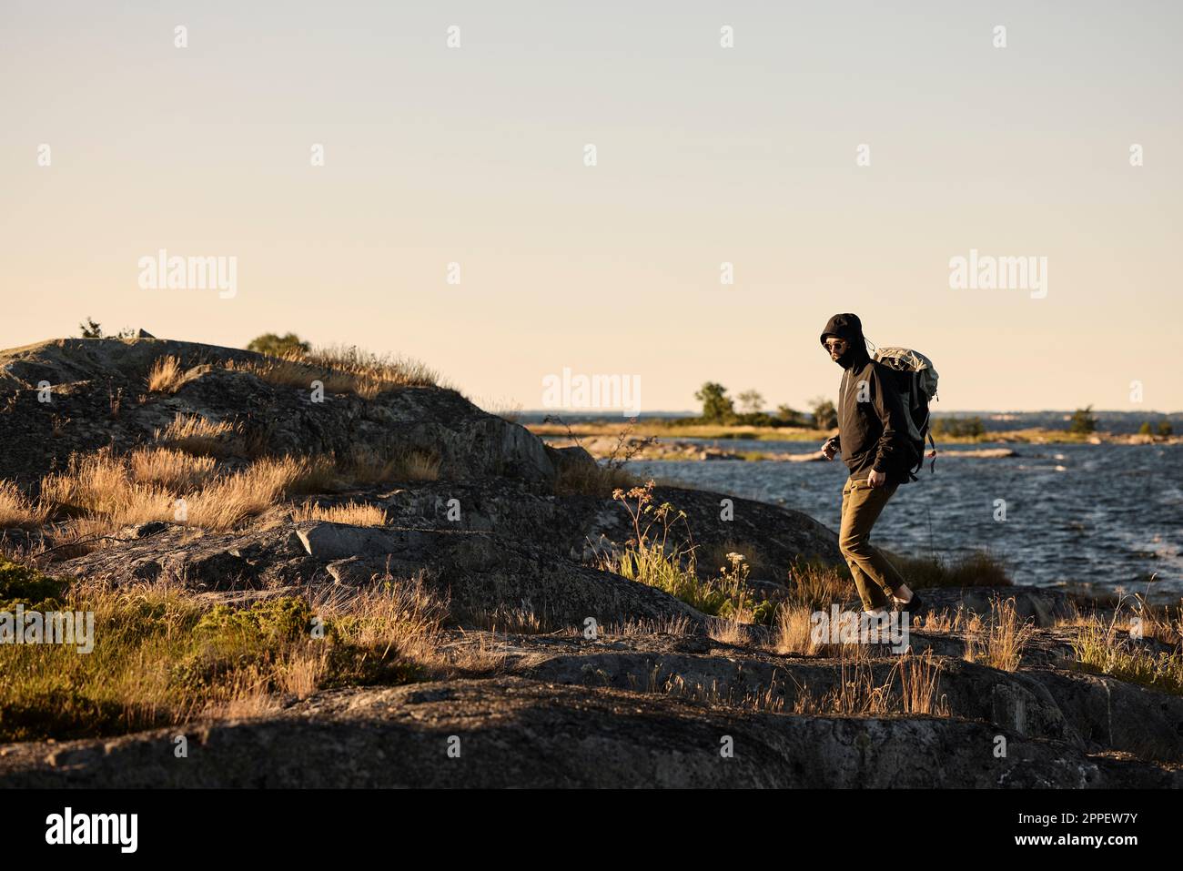 View of backpacker walking at sea Stock Photo - Alamy
