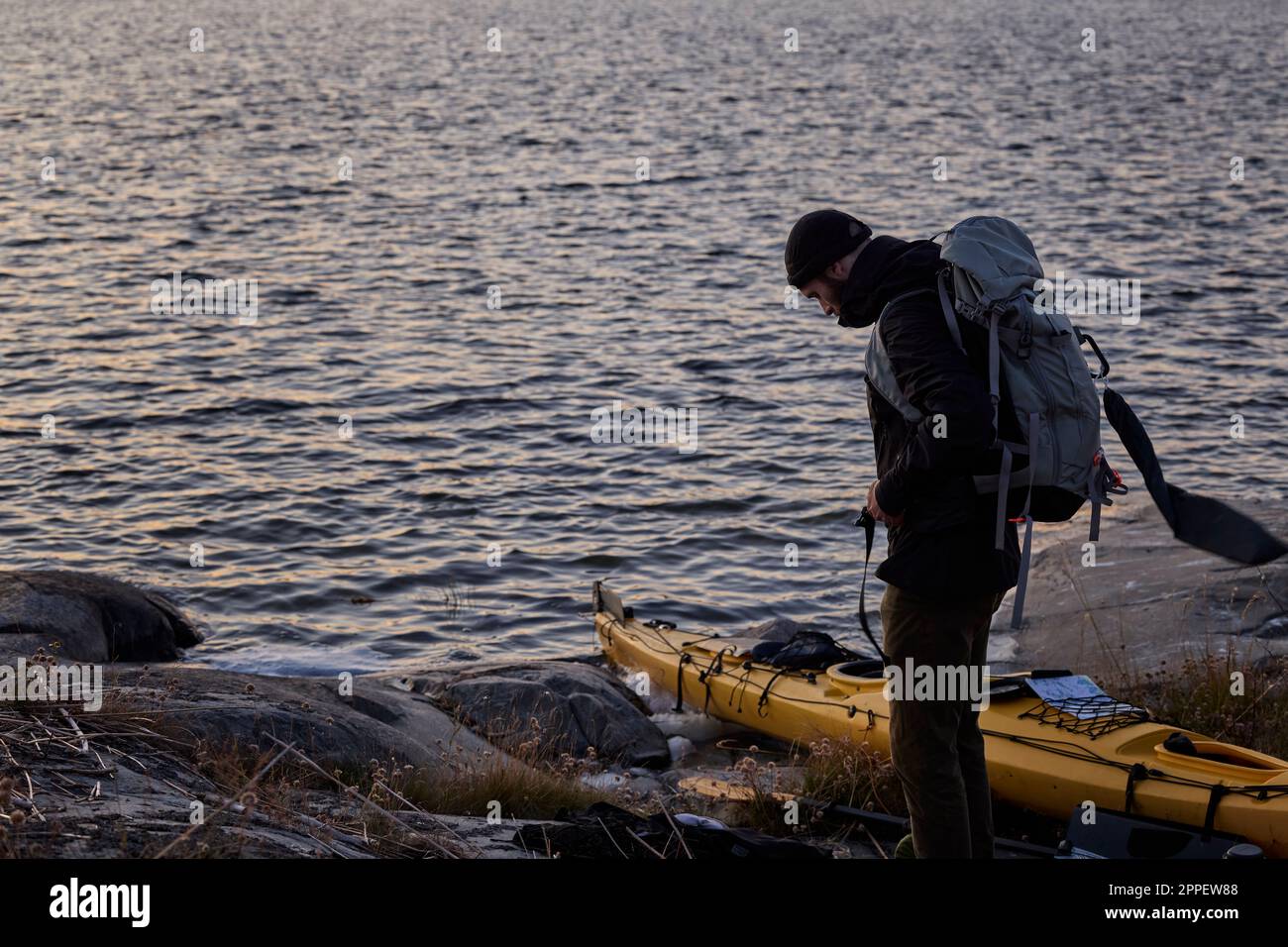 View of backpacker standing at sea Stock Photo - Alamy