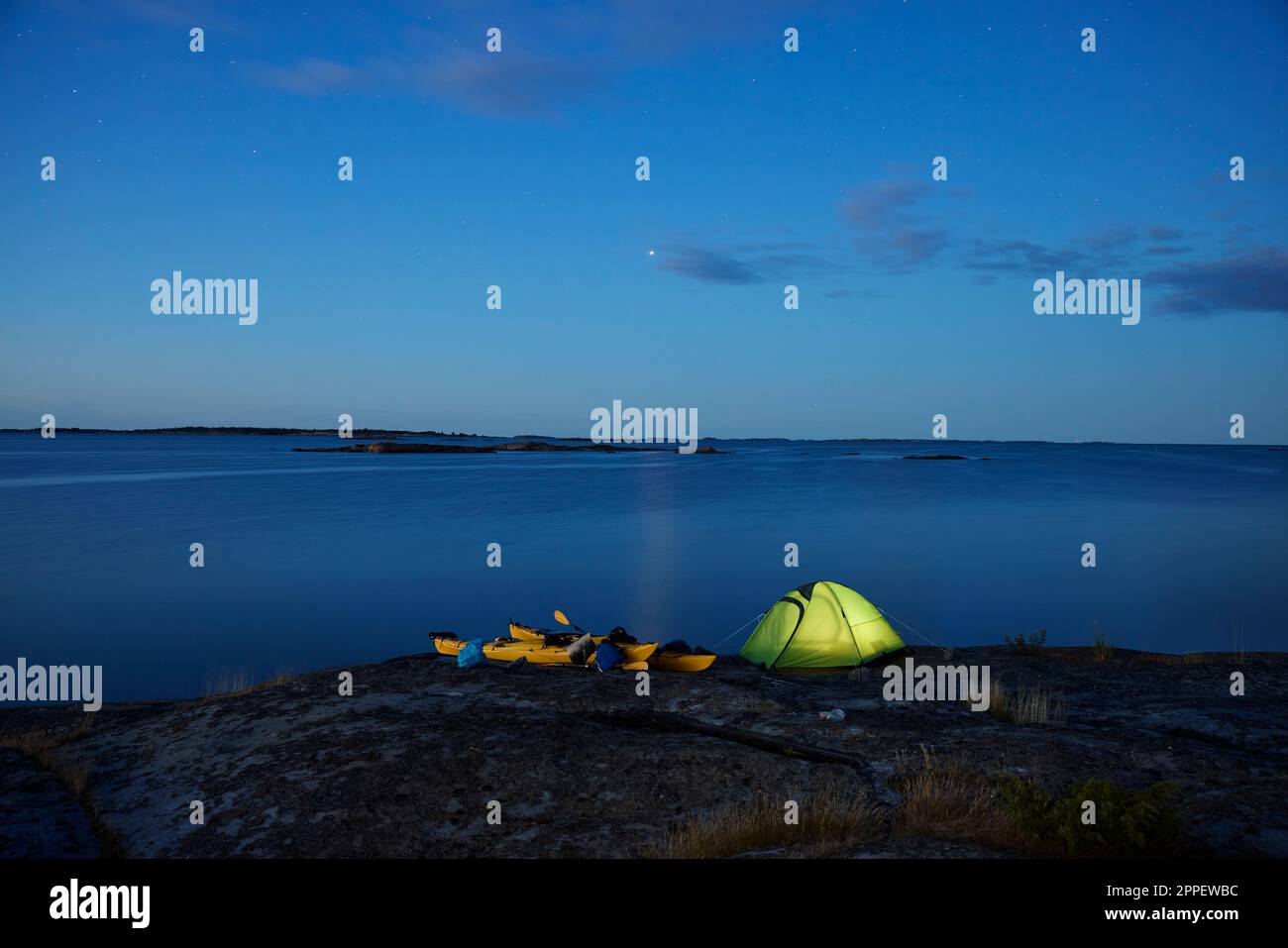 View of illuminated tent at sea Stock Photo - Alamy