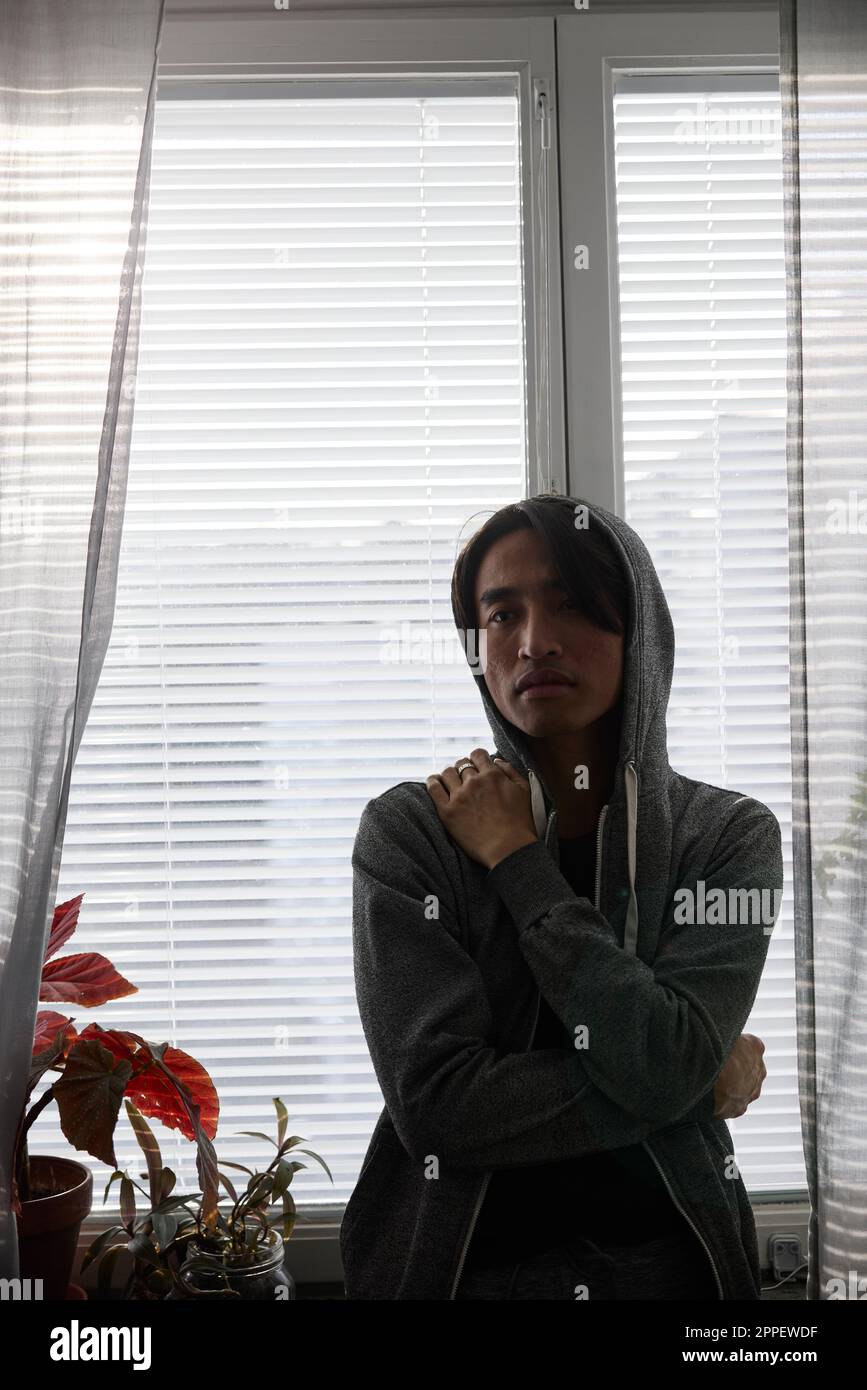 Man standing in front of window Stock Photo - Alamy