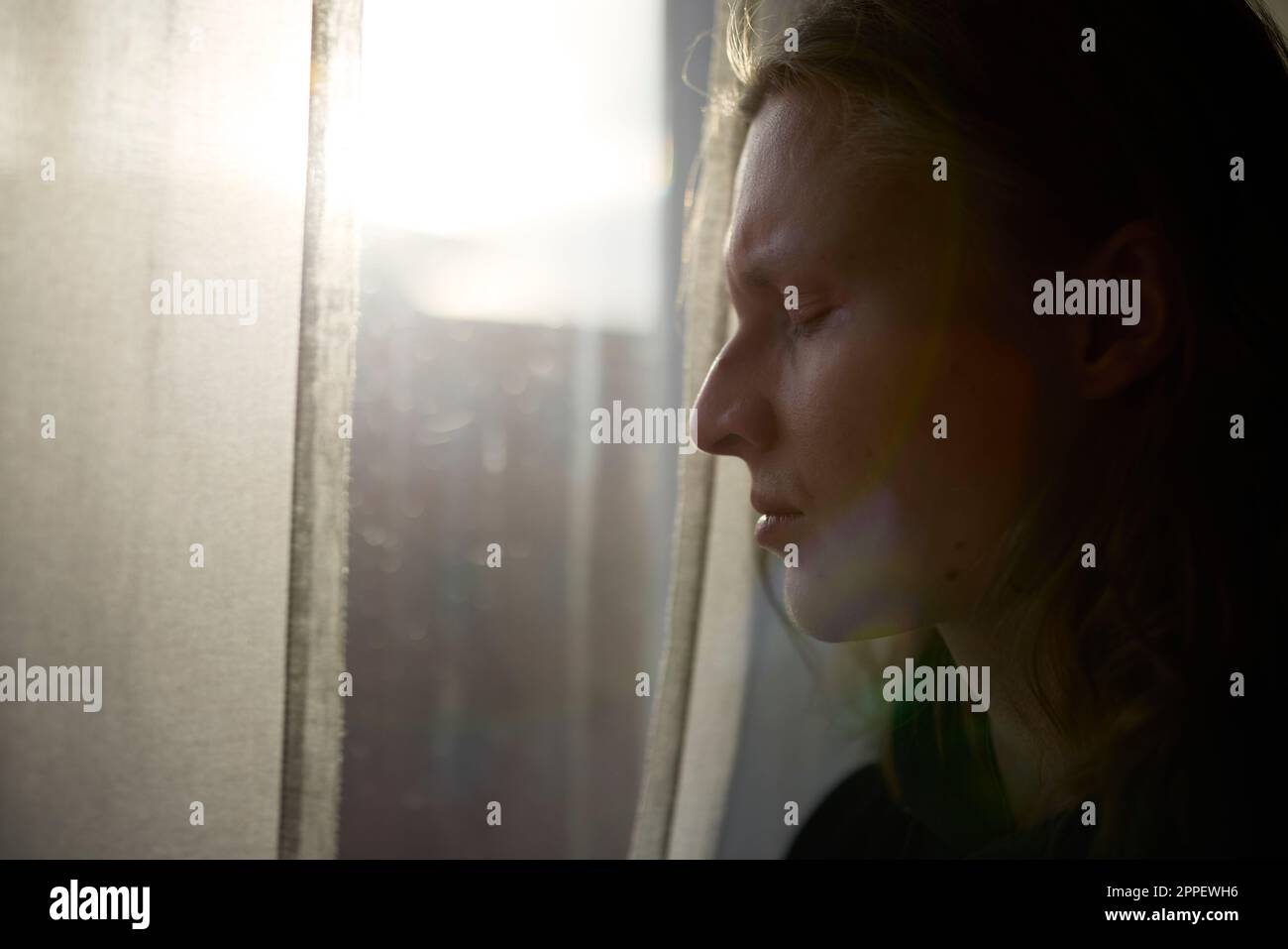 View of woman standing in front of window Stock Photo - Alamy