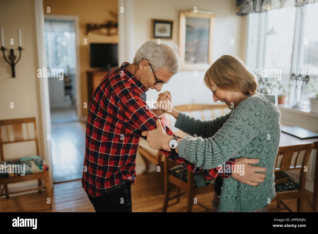 Senior couple dancing at home Stock Photo - Alamy