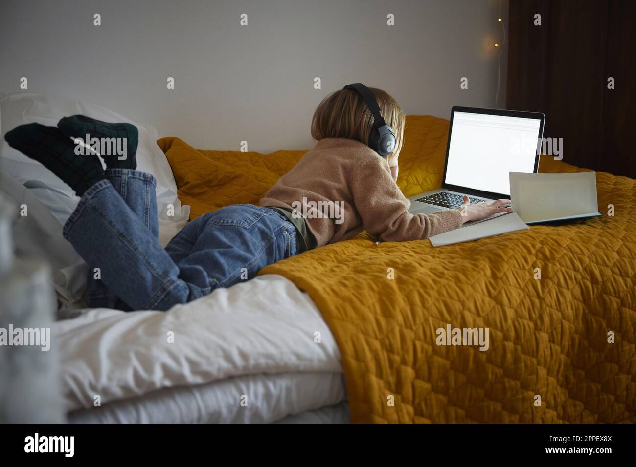 Girl using laptop in her bedroom Stock Photo - Alamy