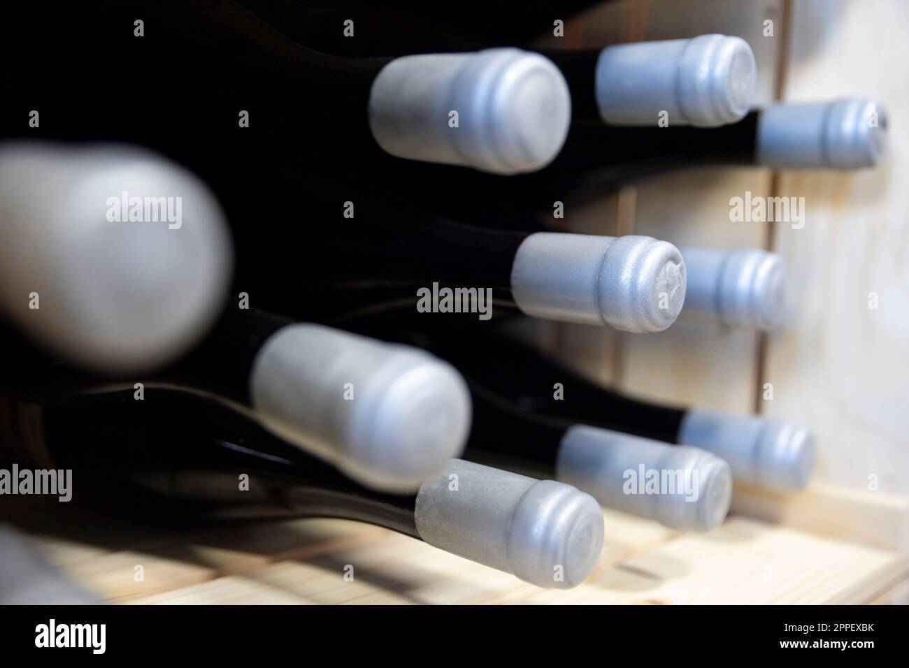 Bottles of wine on wooden shelves in a winery Stock Photo - Alamy