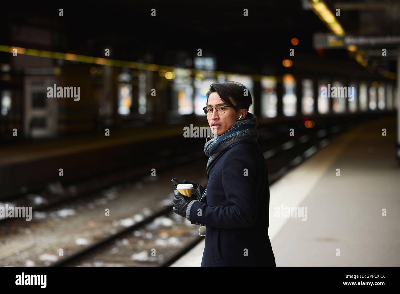 Standing looking away transportation train railway station platform hi ...