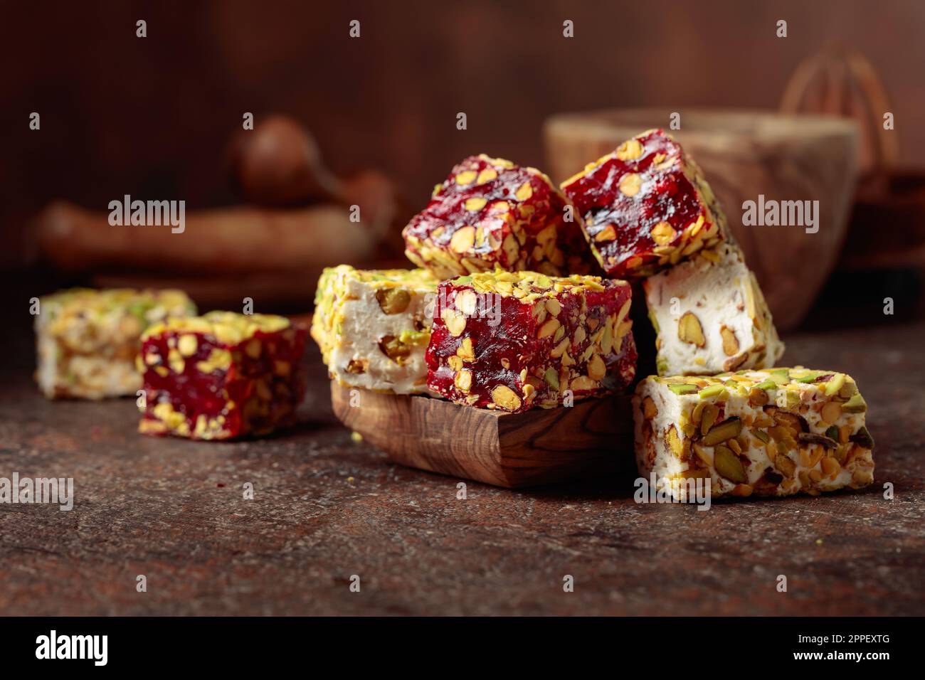 Traditional Turkish delight on an old brown table with wooden kitchen ...