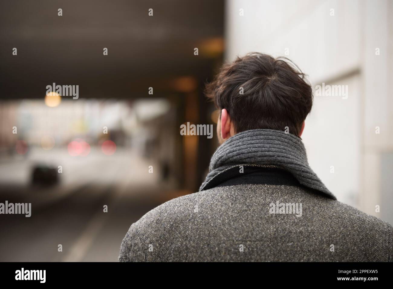 Rear view of man walking in street Stock Photo - Alamy