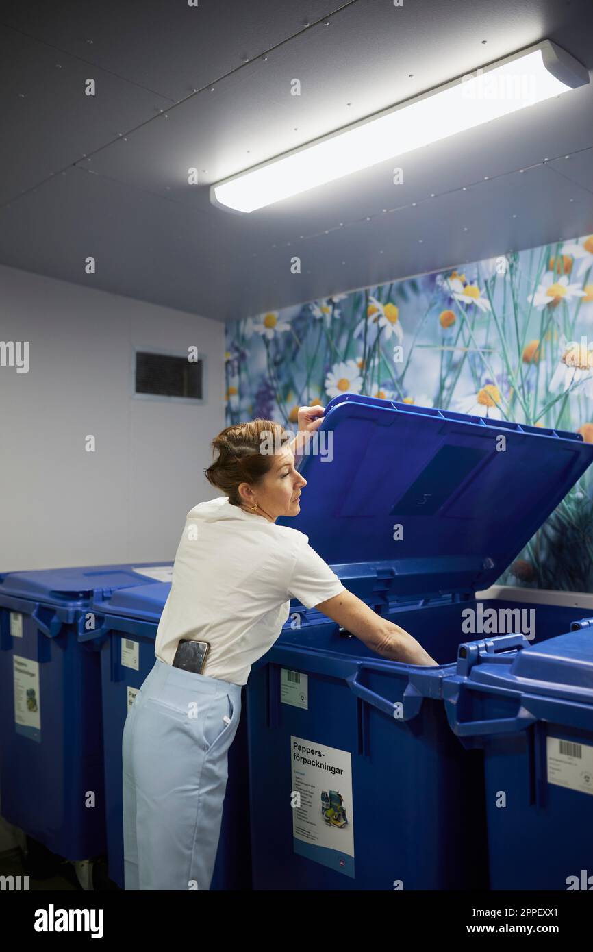 Woman putting waste in recycling bins Stock Photo - Alamy