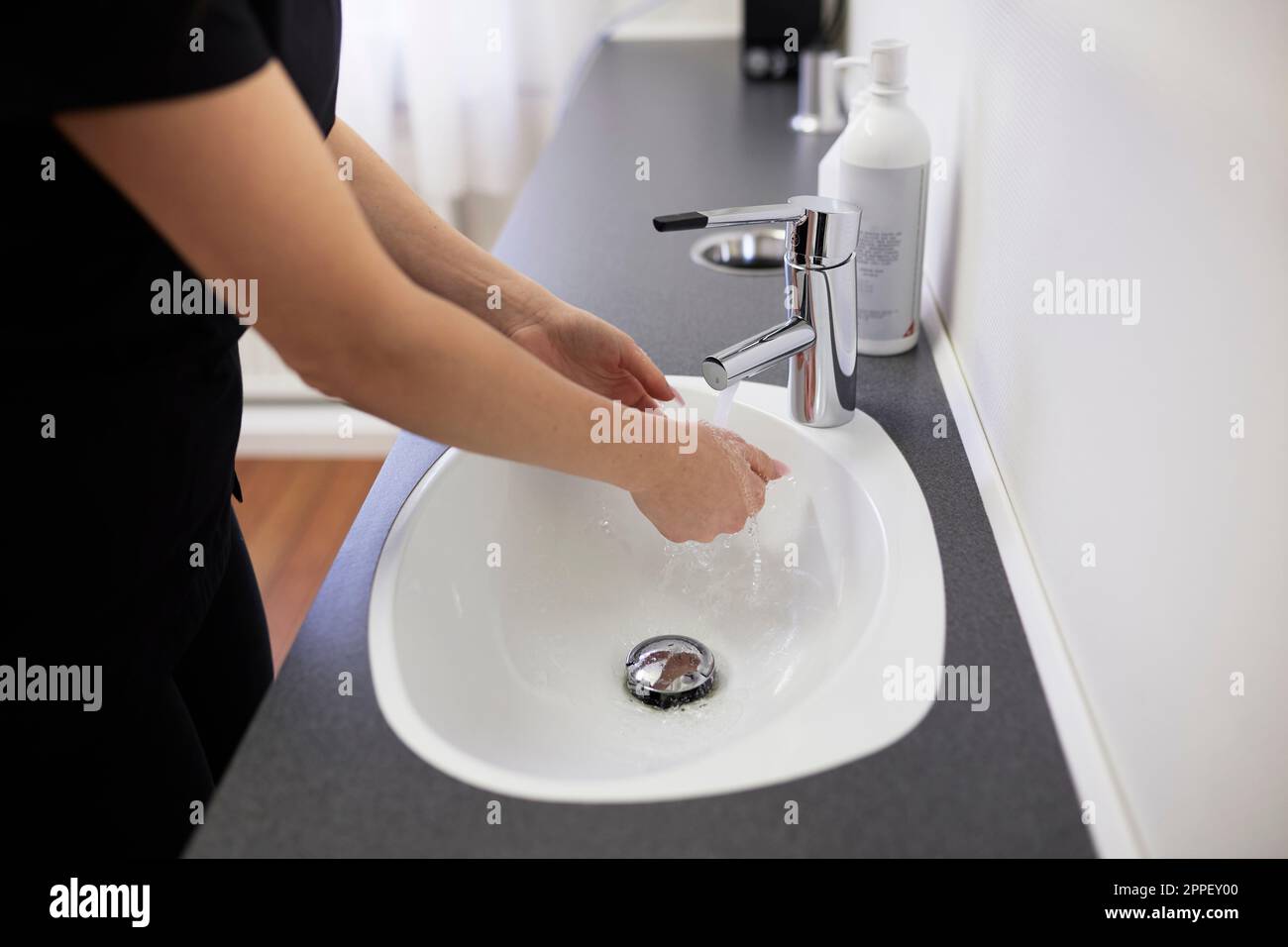Mid section of woman washing hands Stock Photo - Alamy