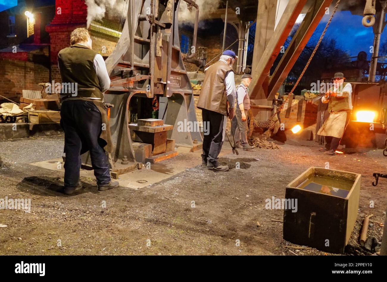 A white-hot ingot of metal is tossed across the workshop by a volunteer to go under the Anchor ...