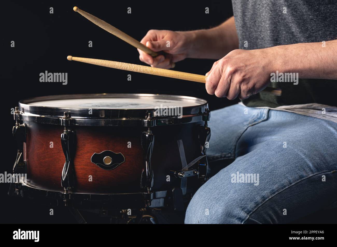 A man plays the snare drum against a dark background Stock Photo - Alamy