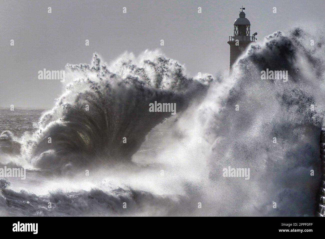 Waves crash over Tynemouth pier on the North East coast of England ...
