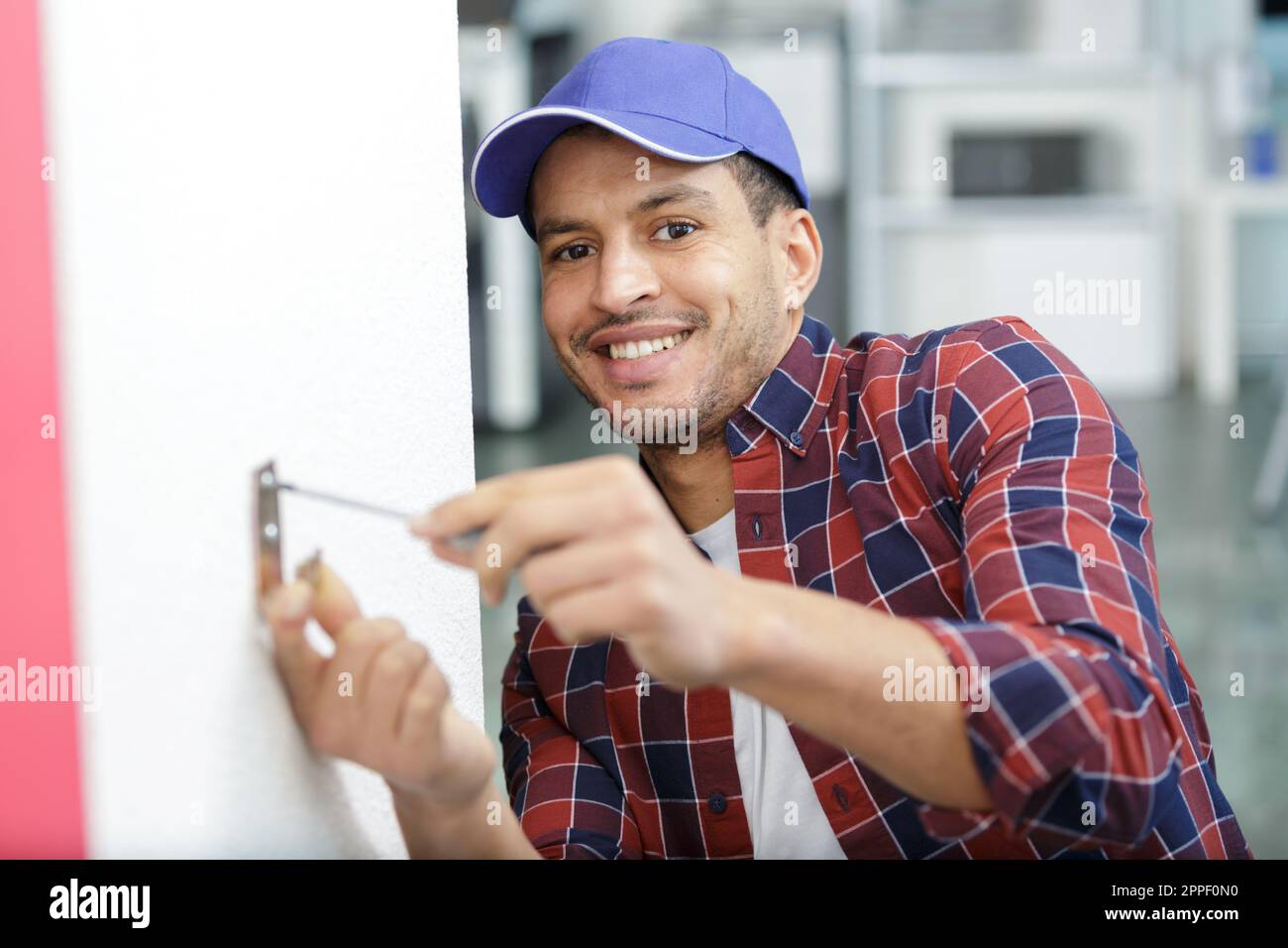 happy man connects an electrical light switch to the wall Stock Photo ...