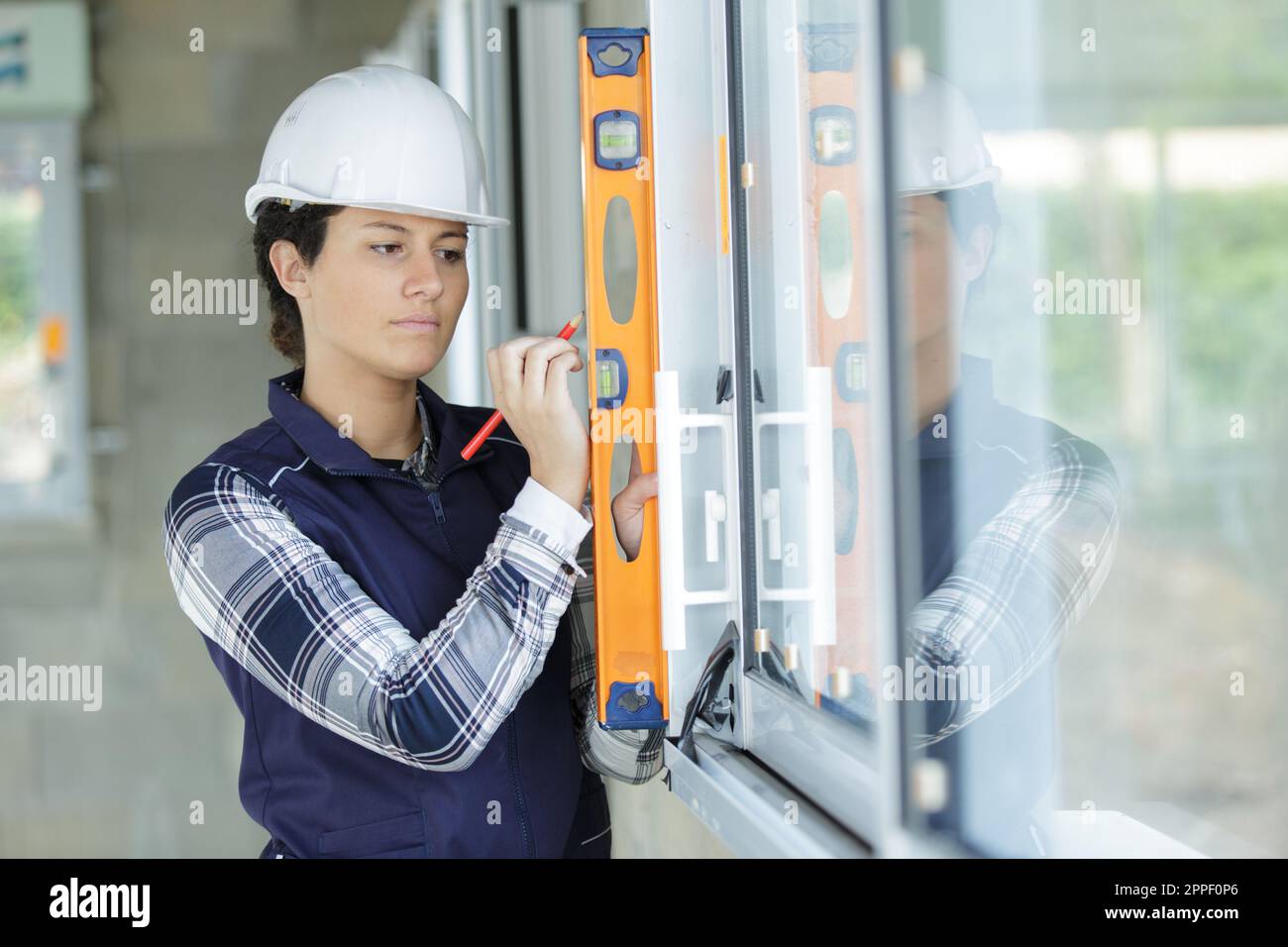 woman verifying measurements using a spirit level Stock Photo - Alamy