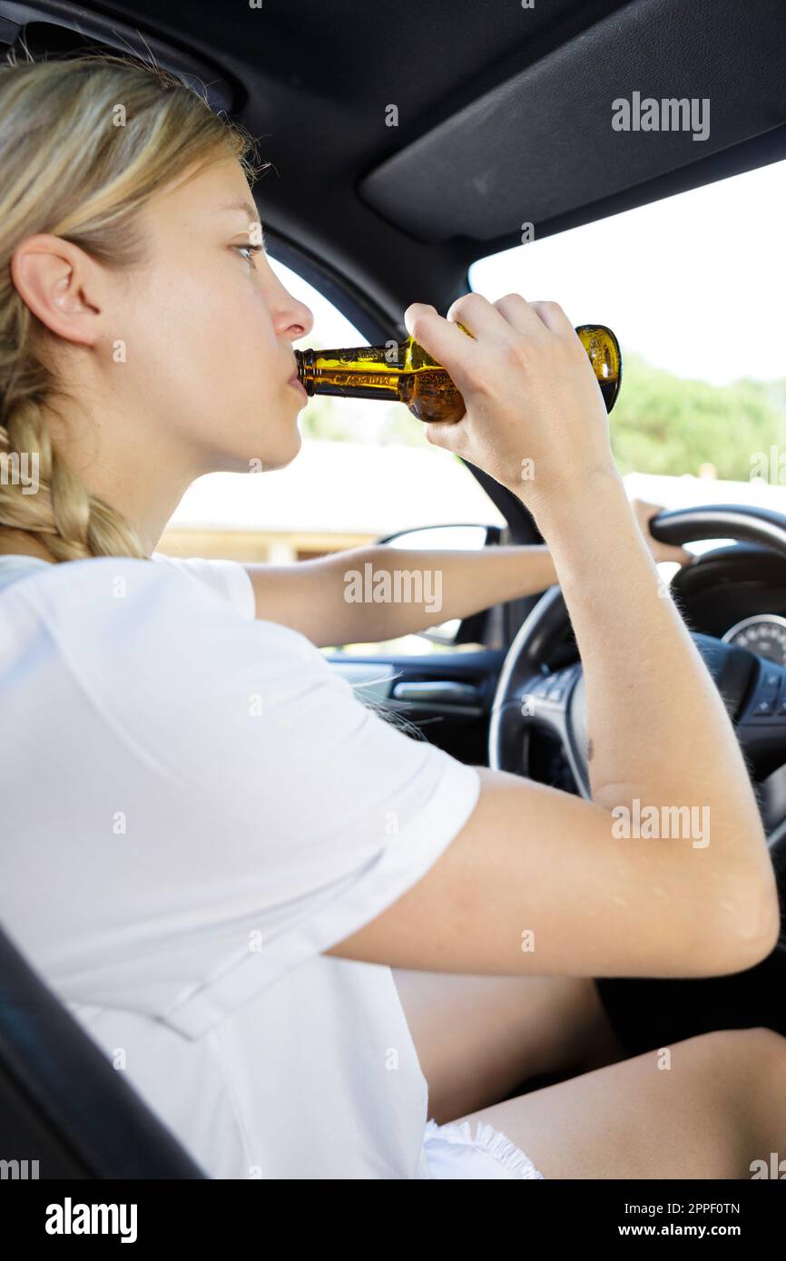 woman drinking beer while driving a car Stock Photo - Alamy