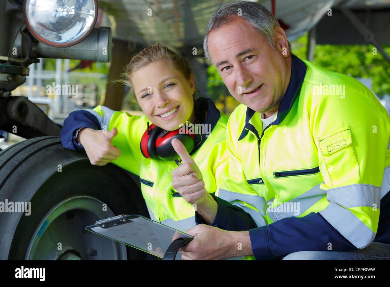 airplane service crew repairing plane in hangar Stock Photo - Alamy
