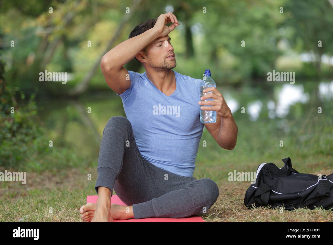 man drinking water after workout outdoors Stock Photo - Alamy