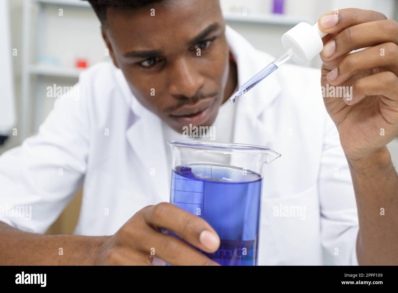 young scientist with violet solution in pipette dropper Stock Photo - Alamy