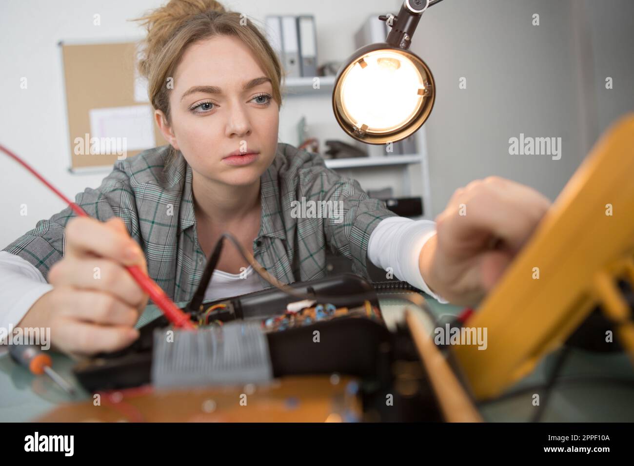 female computer technician using multimeter Stock Photo - Alamy