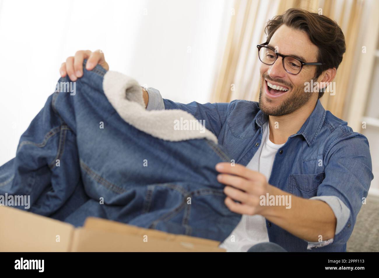 happy man opening cardboard box package Stock Photo - Alamy