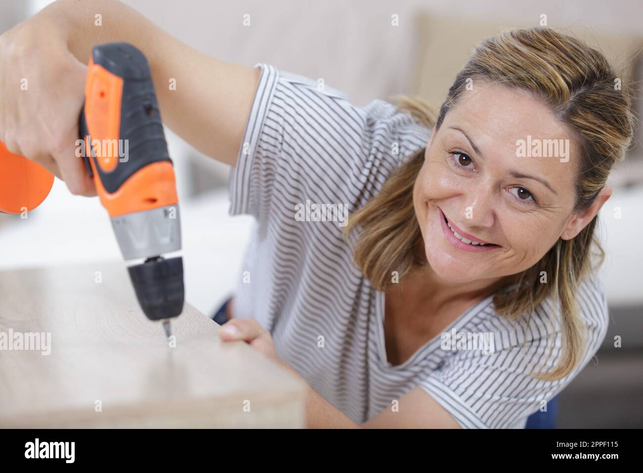 woman using cordless screwdriver at home Stock Photo - Alamy