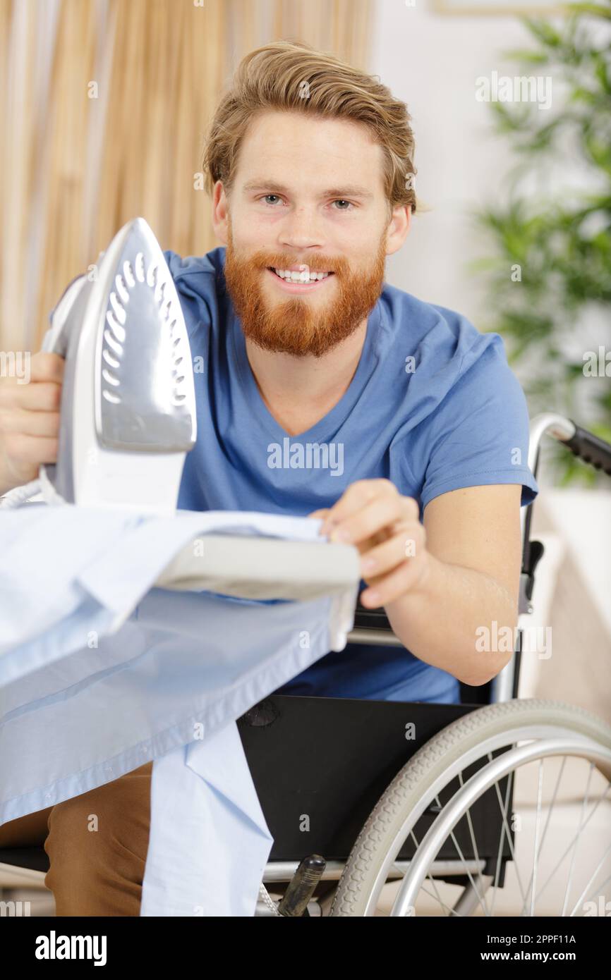 a young disable man ironing Stock Photo - Alamy