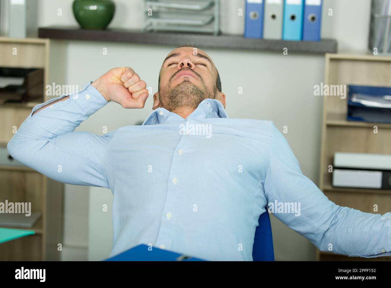 male office worker stretching his back Stock Photo - Alamy