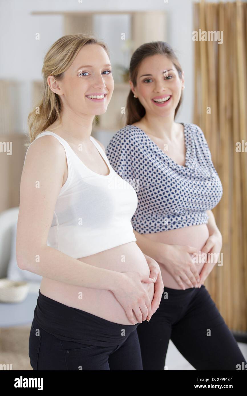 two pregnant girlfriend looking at camera Stock Photo - Alamy