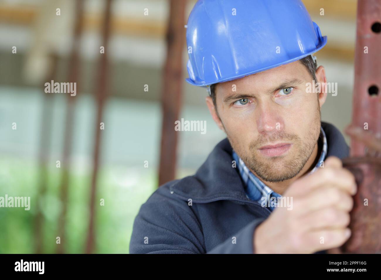 builder standing with ventilation pipe indoors Stock Photo - Alamy
