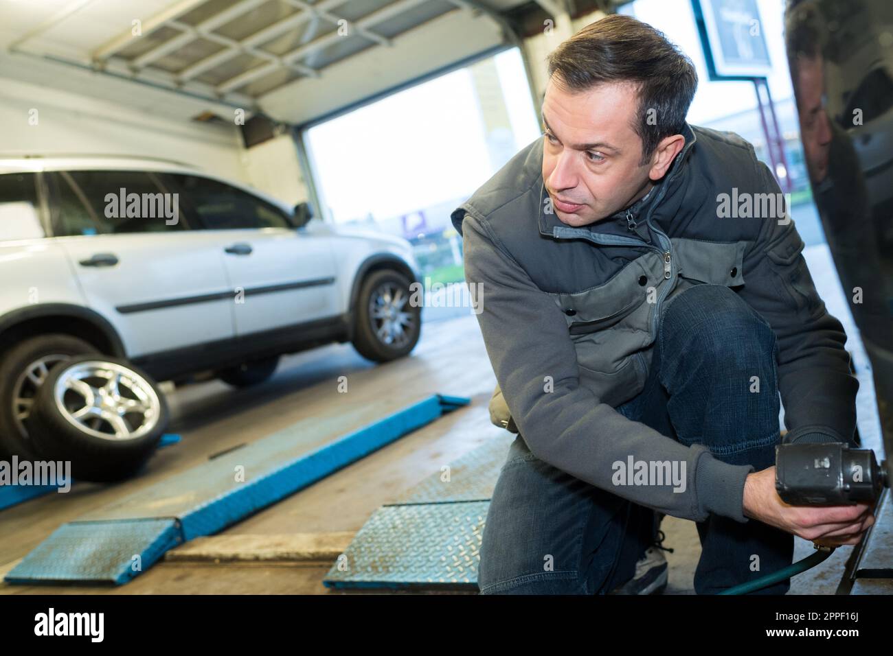 Attractive mechanic working garage hi-res stock photography and images ...