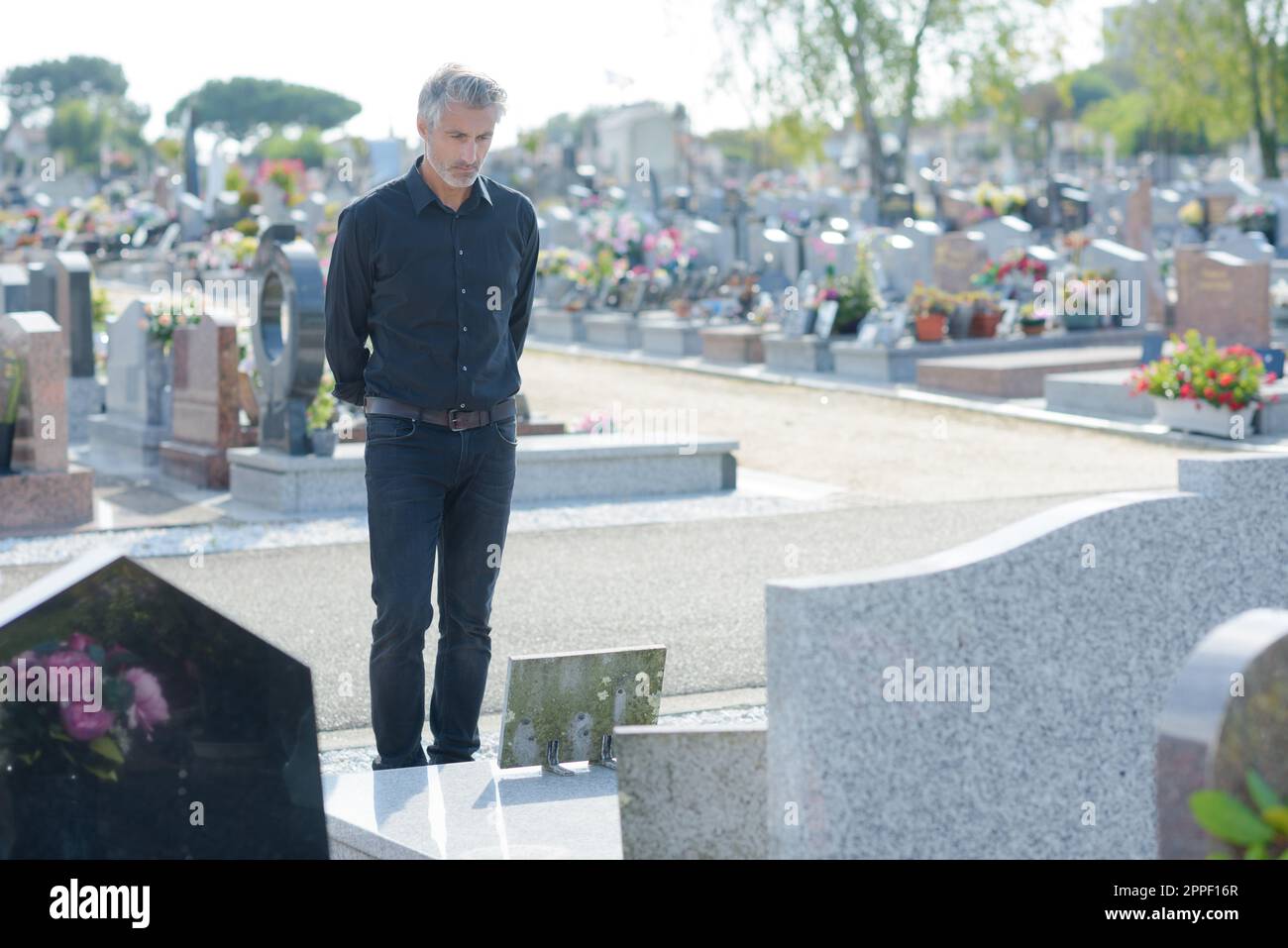 portrait of man in cemetery Stock Photo - Alamy