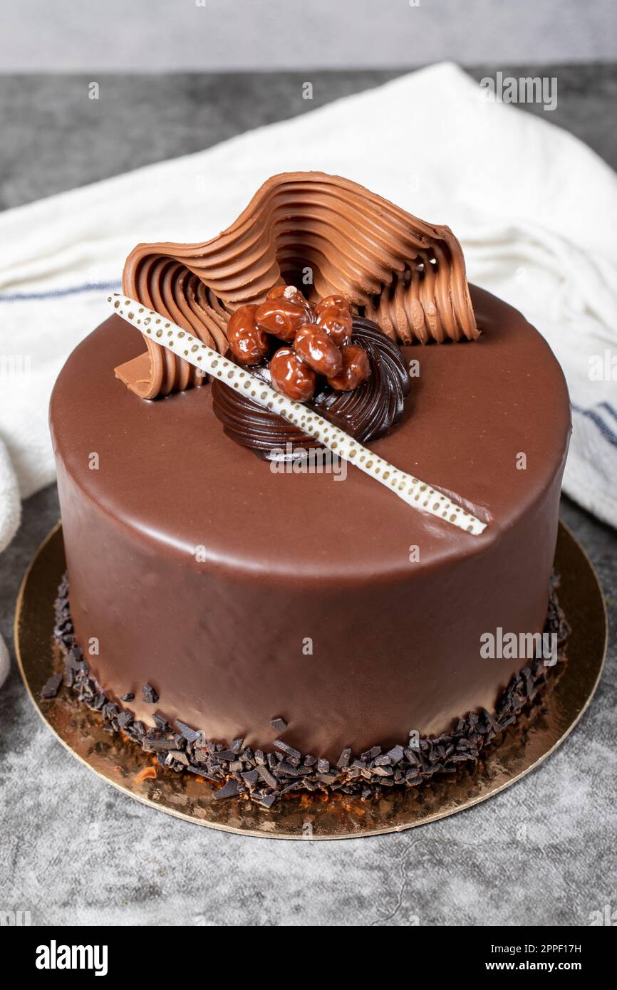 Chocolate cream cake. Chocolate birthday cake on dark background ...