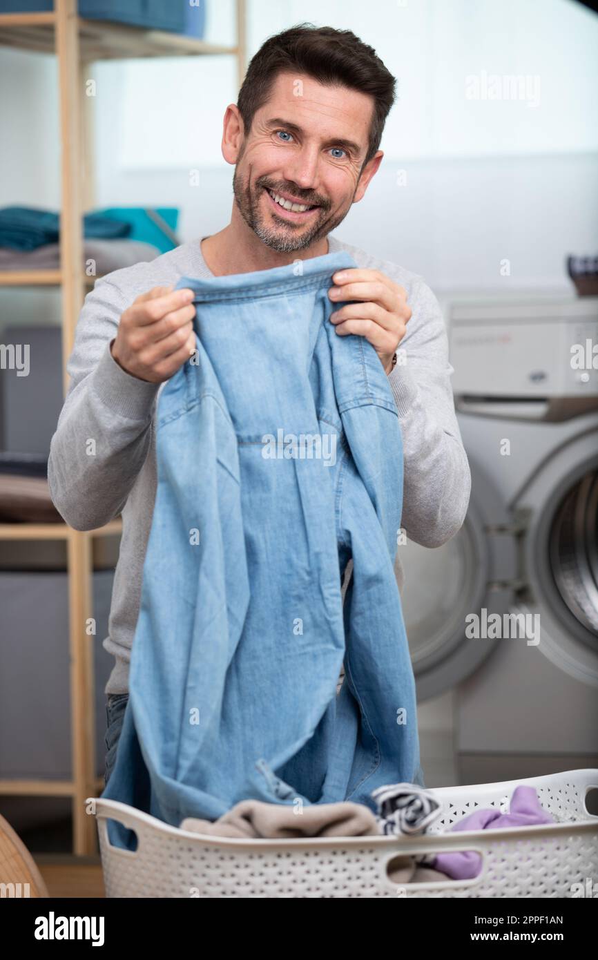 happy man doing laundry at home Stock Photo - Alamy