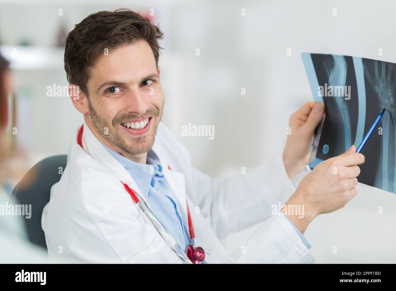 portrait of a male doctor with x-ray at medical office Stock Photo - Alamy