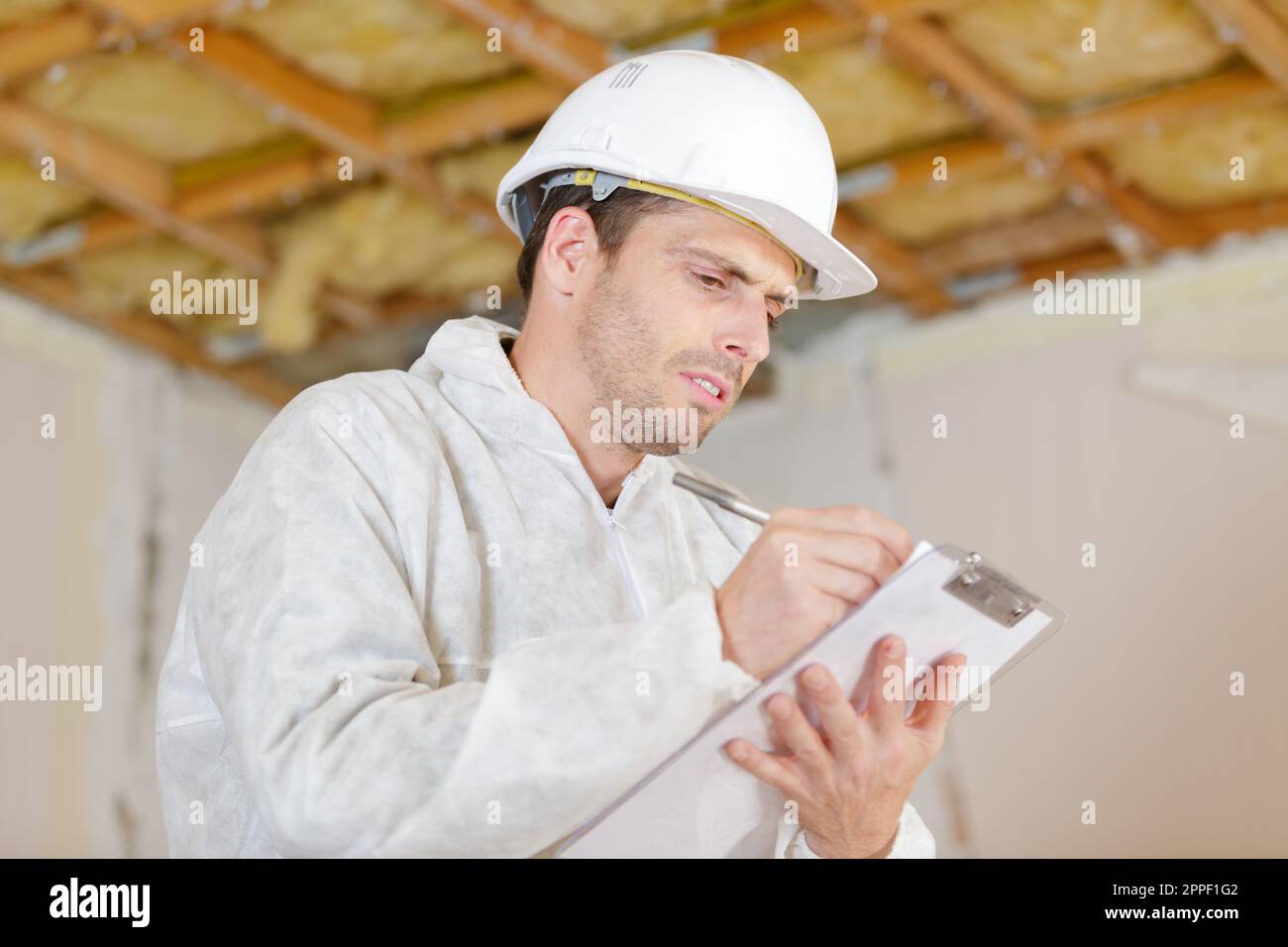 a builder in a with clipboard Stock Photo - Alamy